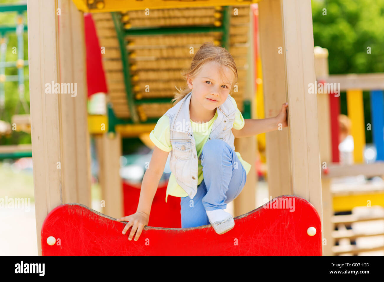happy little girl climbing on children playground Stock Photo - Alamy