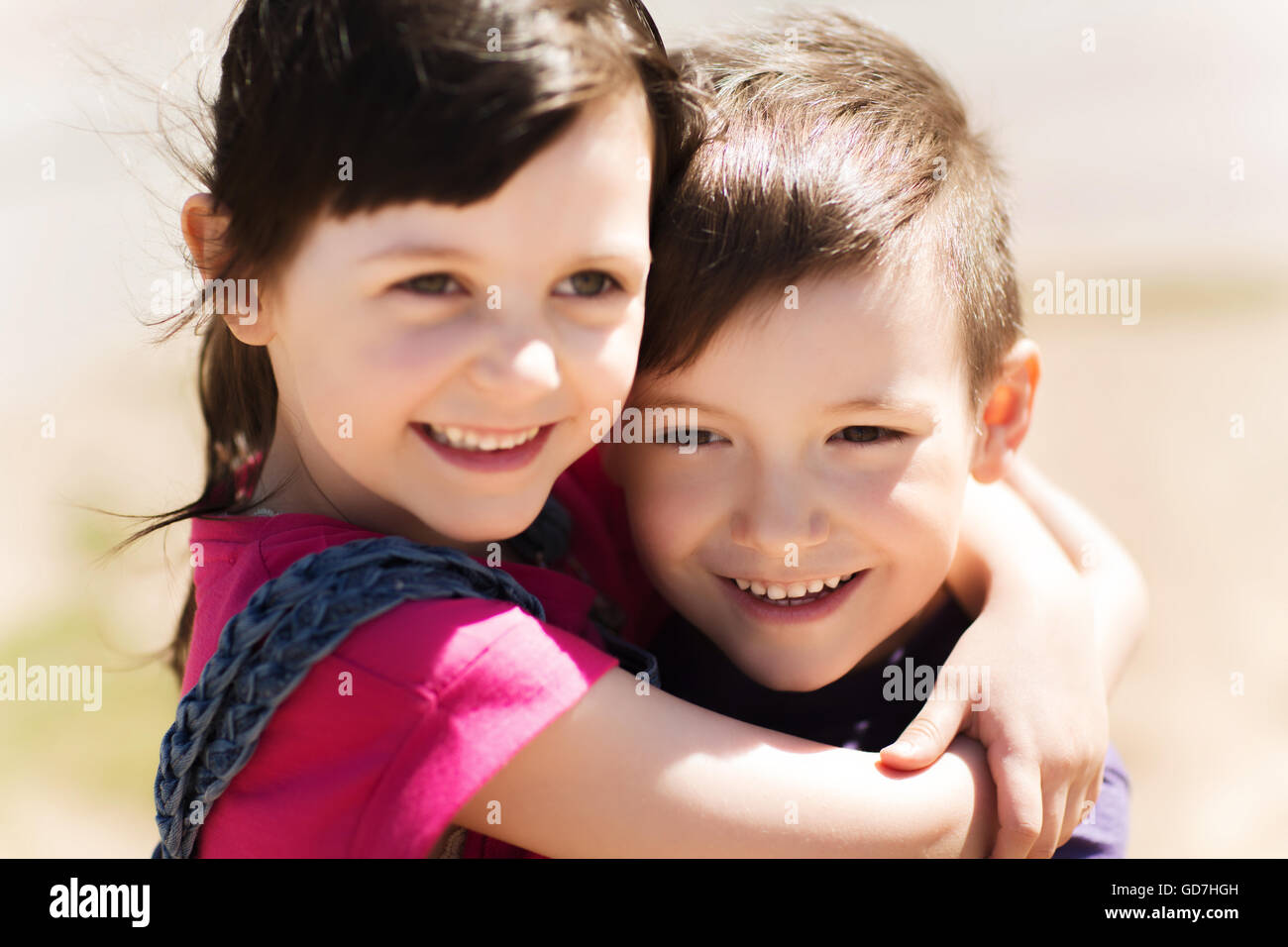 two happy kids hugging outdoors Stock Photo - Alamy
