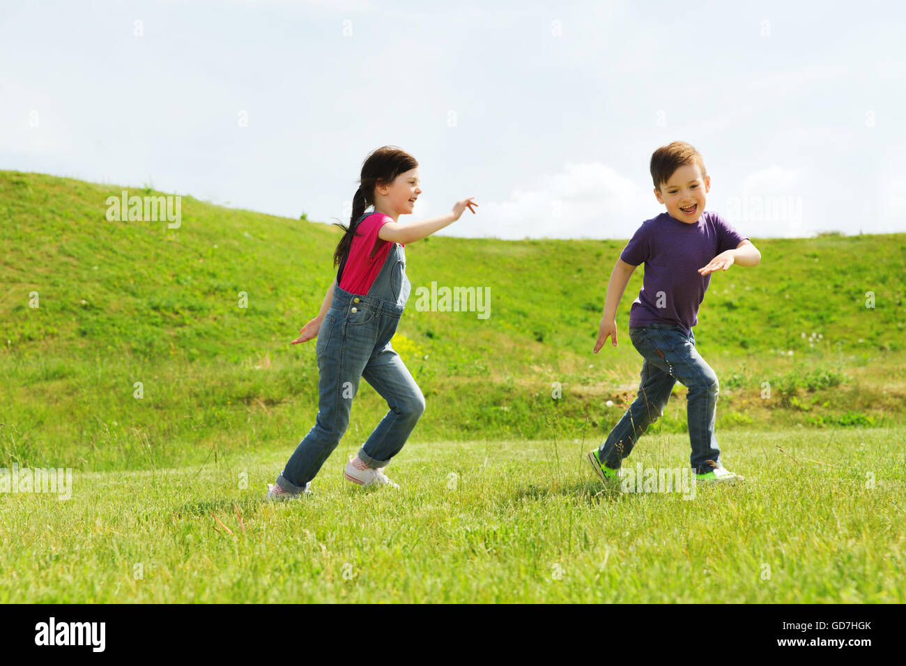 happy little boy and girl running outdoors Stock Photo - Alamy