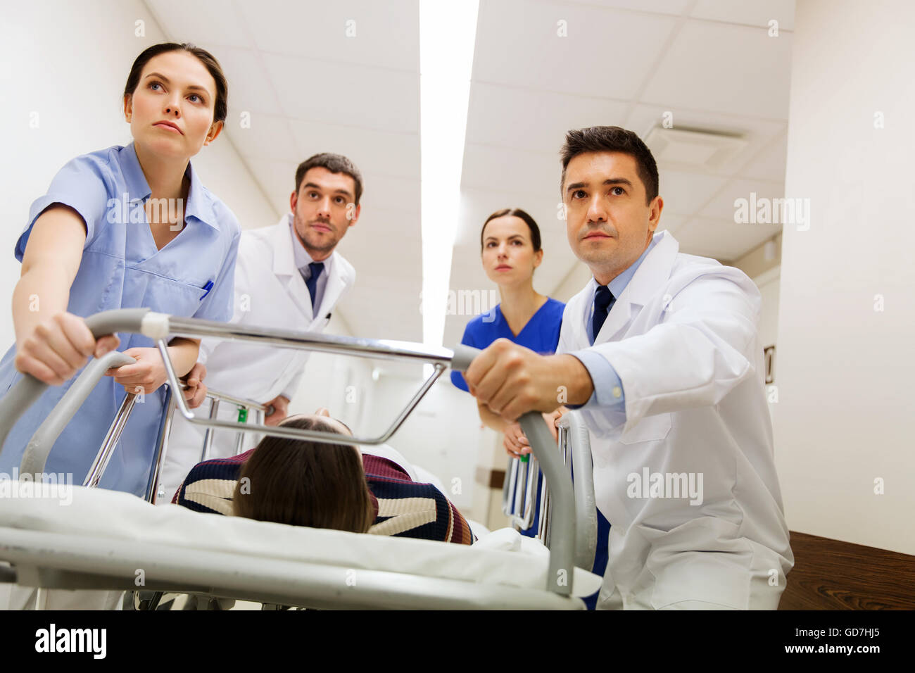 medics with woman on hospital gurney at emergency Stock Photo - Alamy