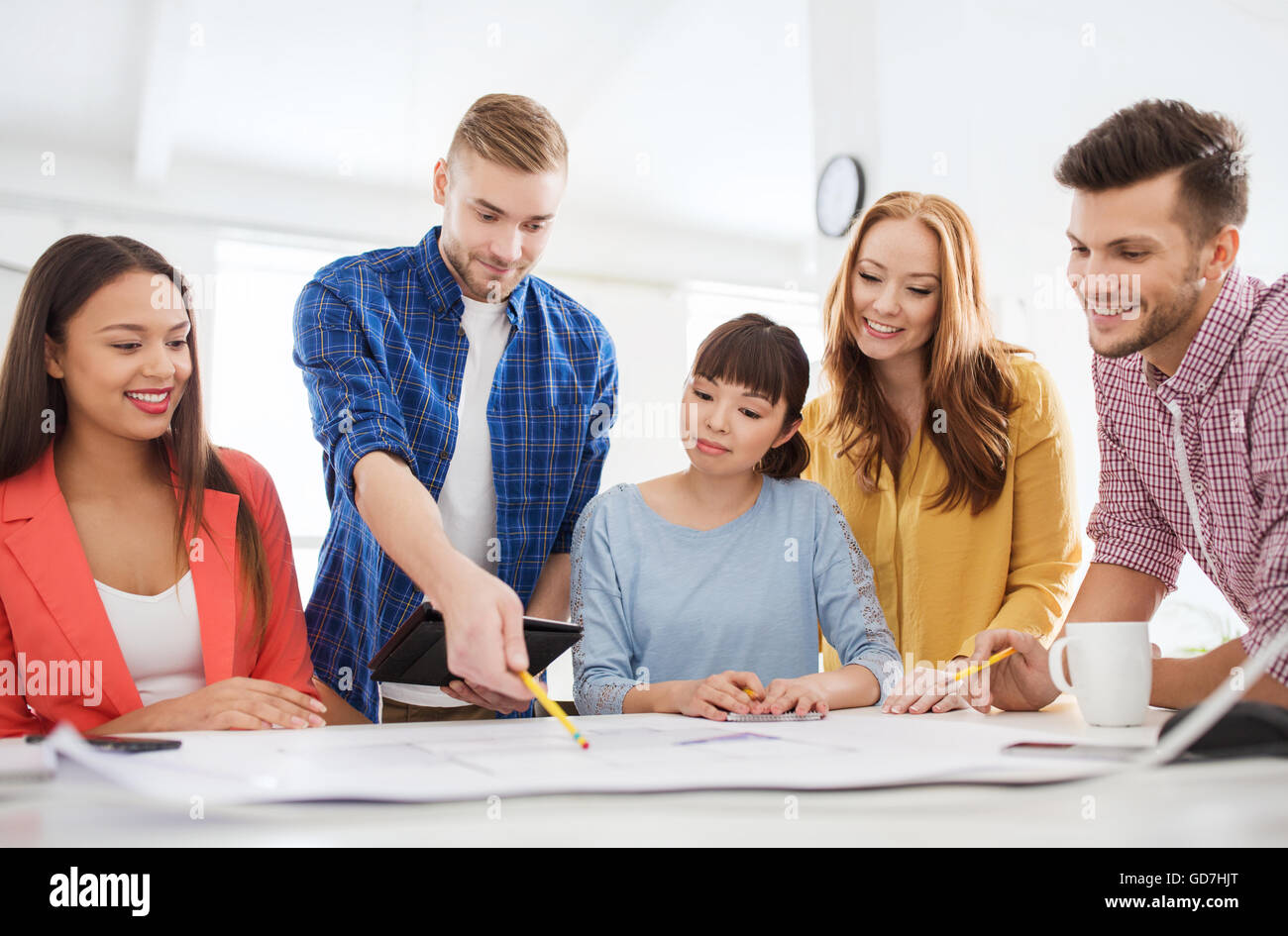 creative team with blueprint working at office Stock Photo - Alamy