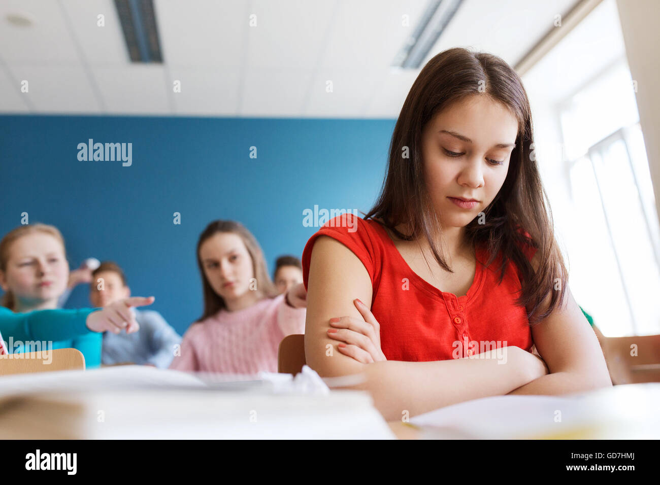 students gossiping behind classmate back at school Stock Photo - Alamy