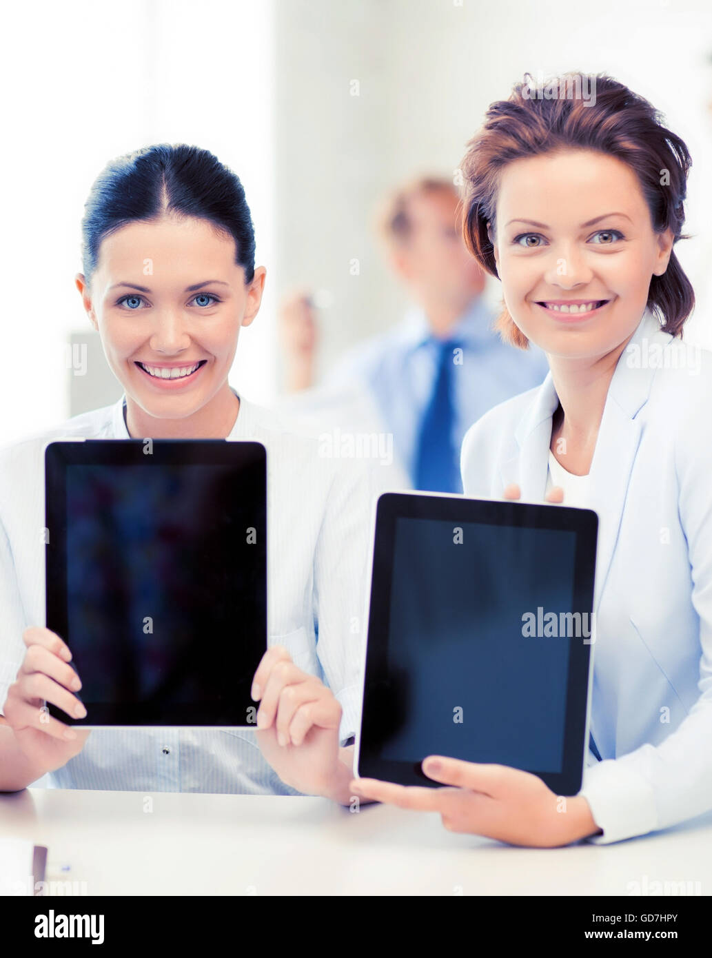 business team showing tablet pcs in office Stock Photo - Alamy