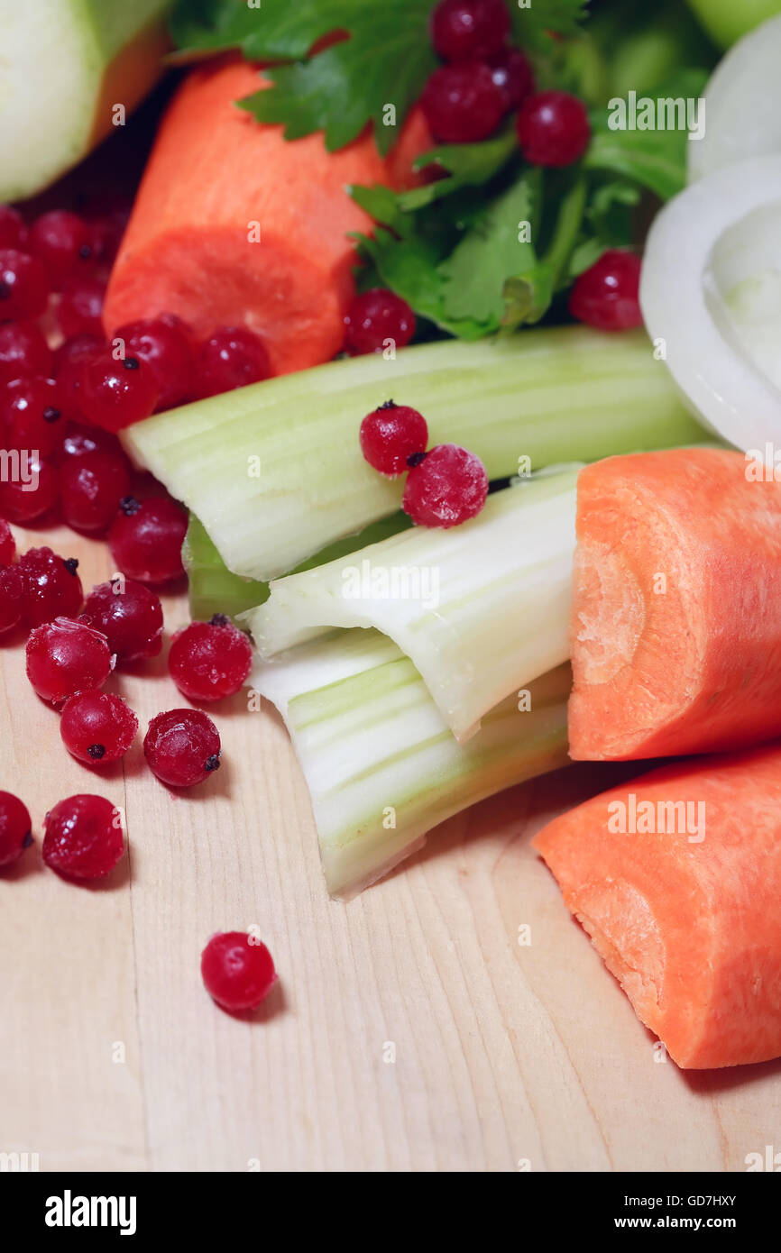 Set of raw vegetables and frozen cranberry on wooden board Stock Photo ...