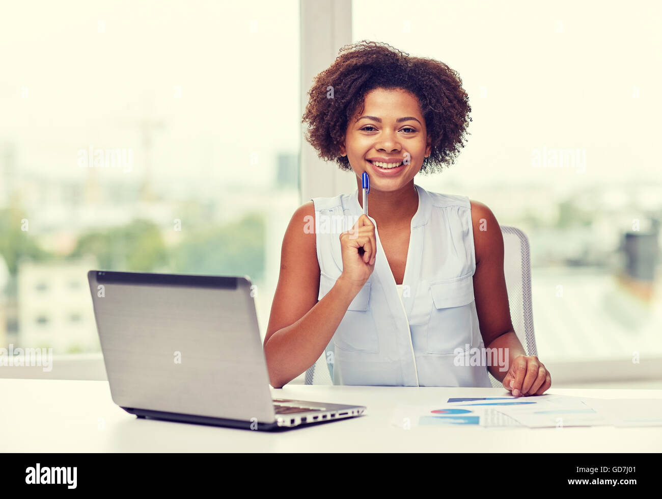 happy african woman with laptop at office Stock Photo - Alamy