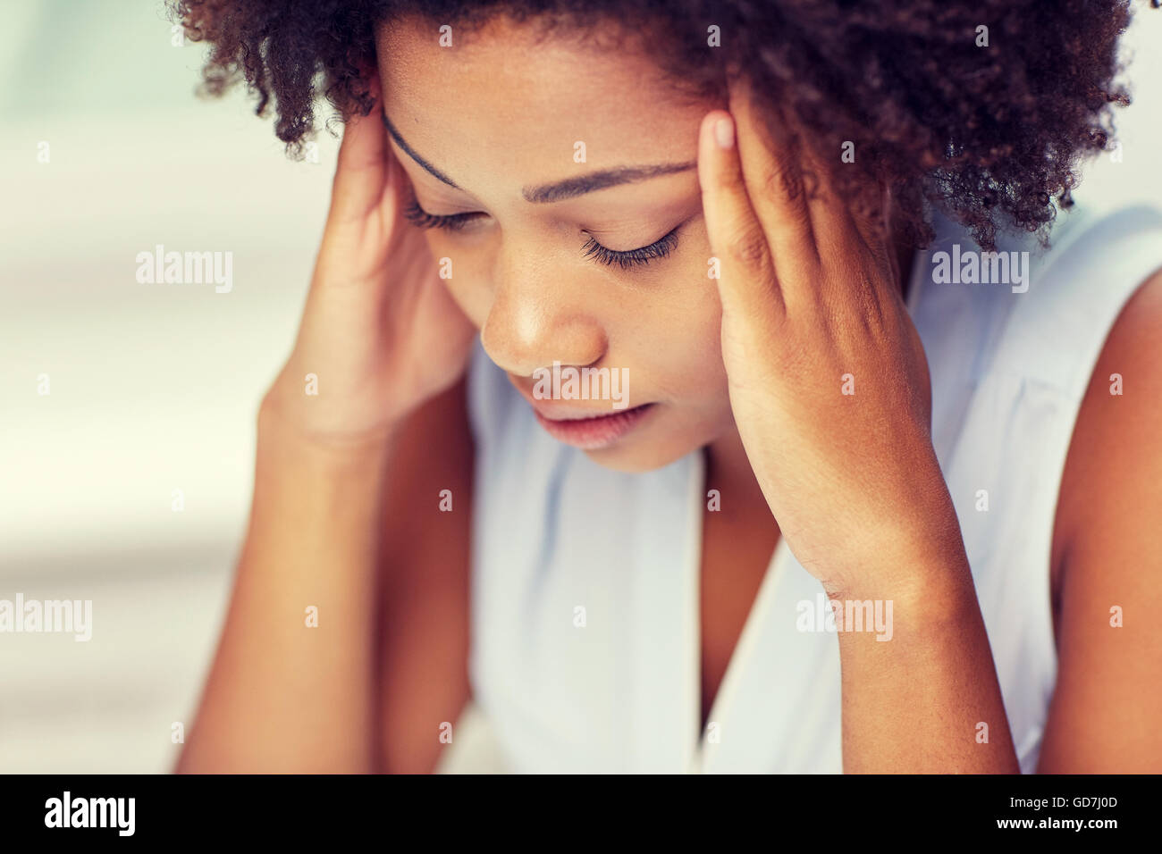 close up of african young woman touching her head Stock Photo - Alamy