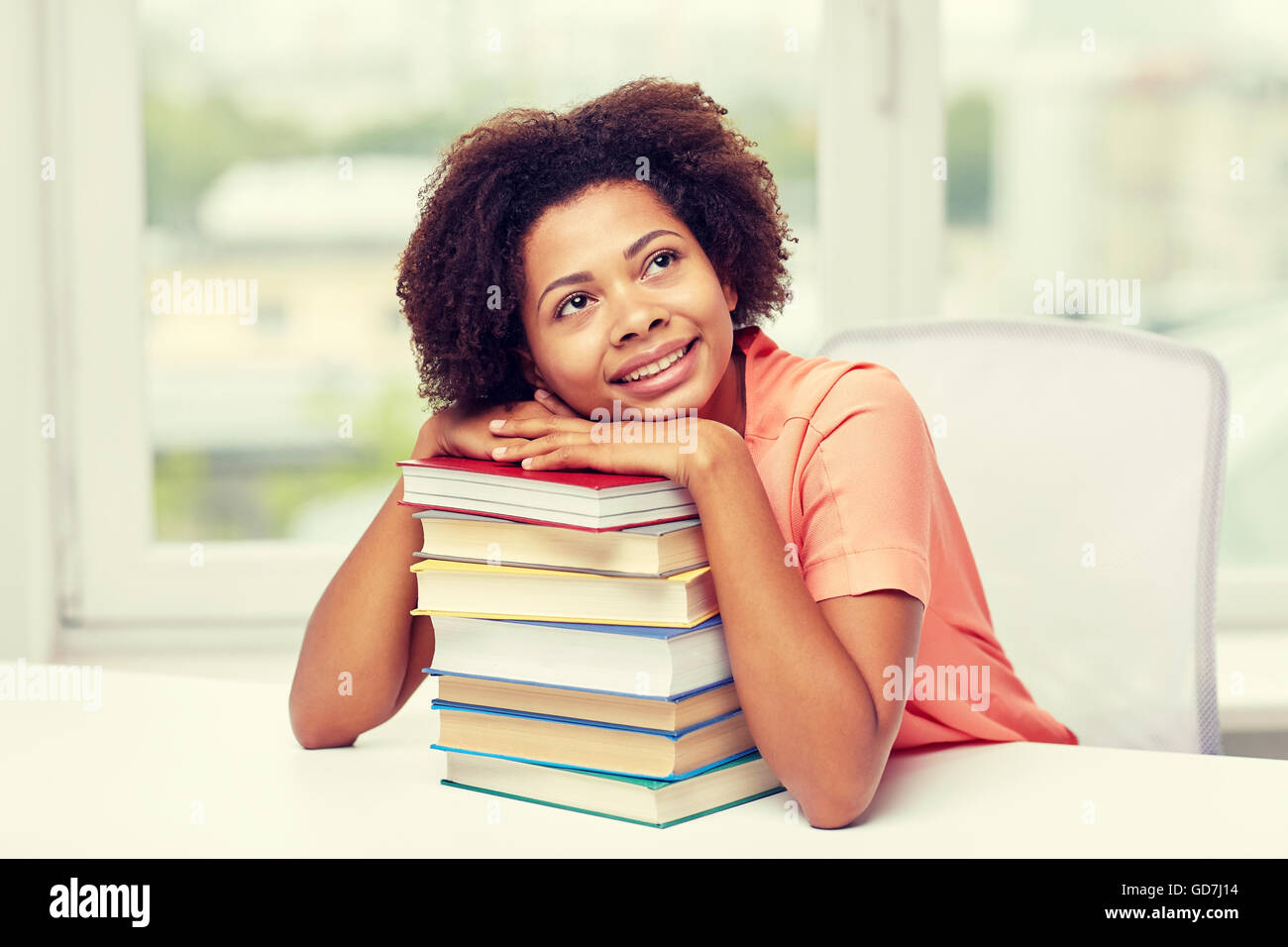 happy african student girl with books at home Stock Photo - Alamy