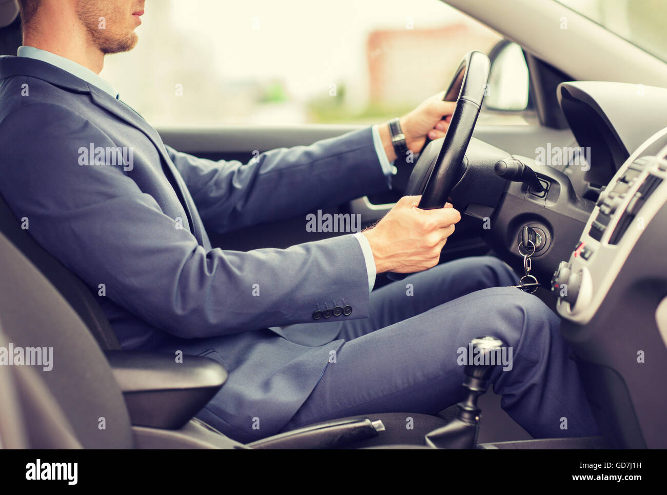 close up of young man in suit driving car Stock Photo - Alamy