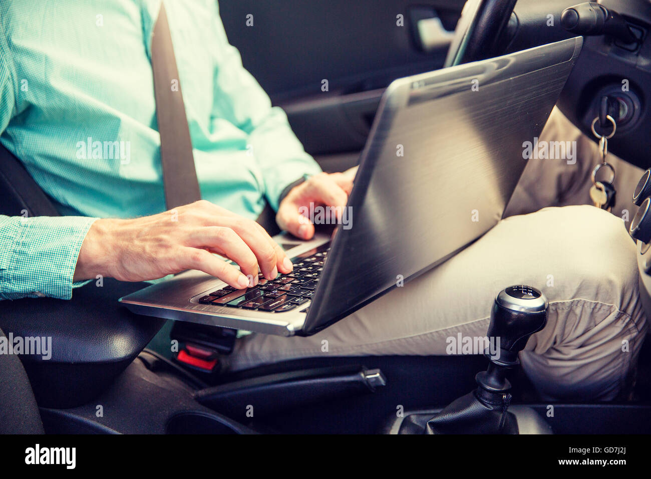 close up of young man with laptop driving car Stock Photo - Alamy