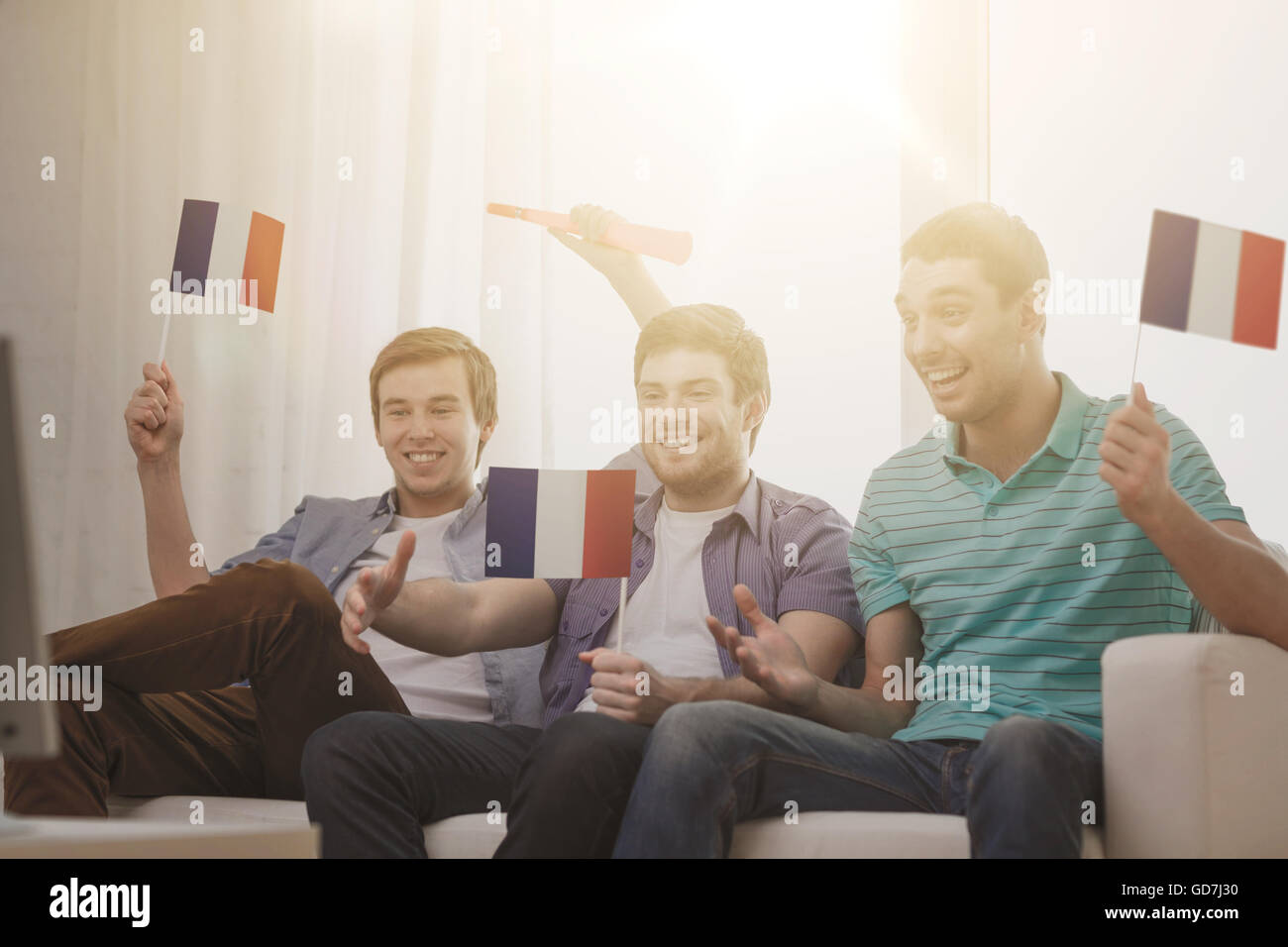 happy male friends with flags and vuvuzela Stock Photo - Alamy