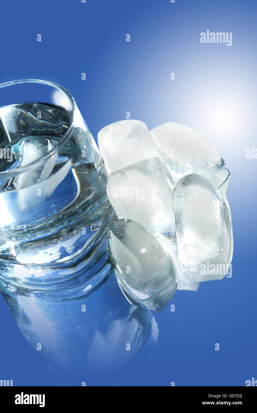 Glass of cold water with ice cubes on blue background Stock Photo - Alamy