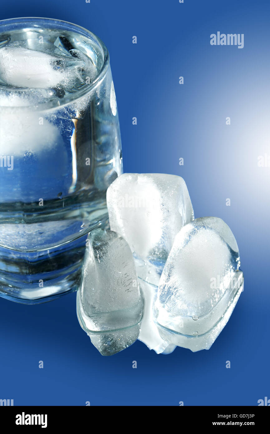 Glass of cold water with ice cubes on blue background Stock Photo - Alamy