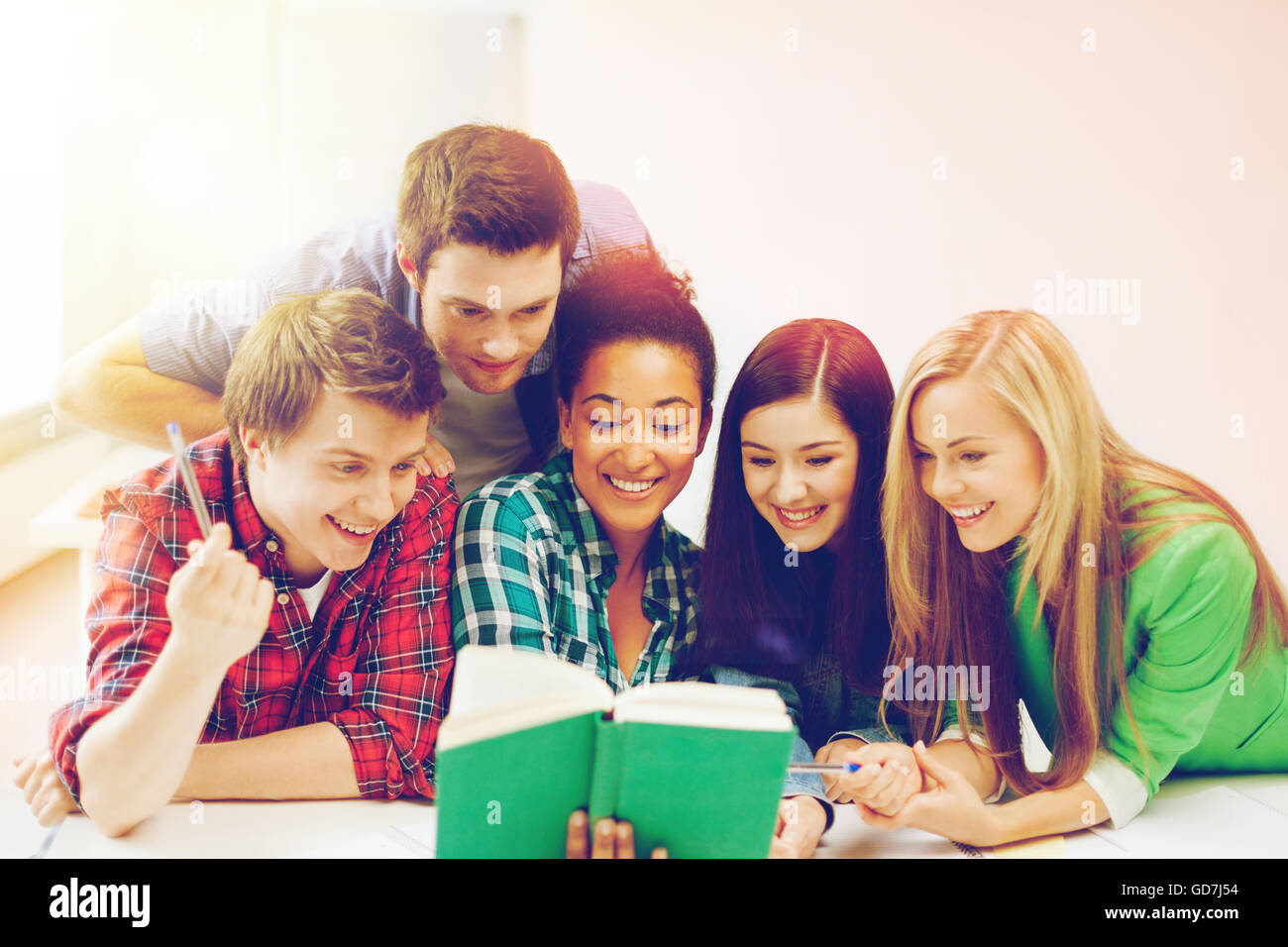 students reading book at school Stock Photo - Alamy