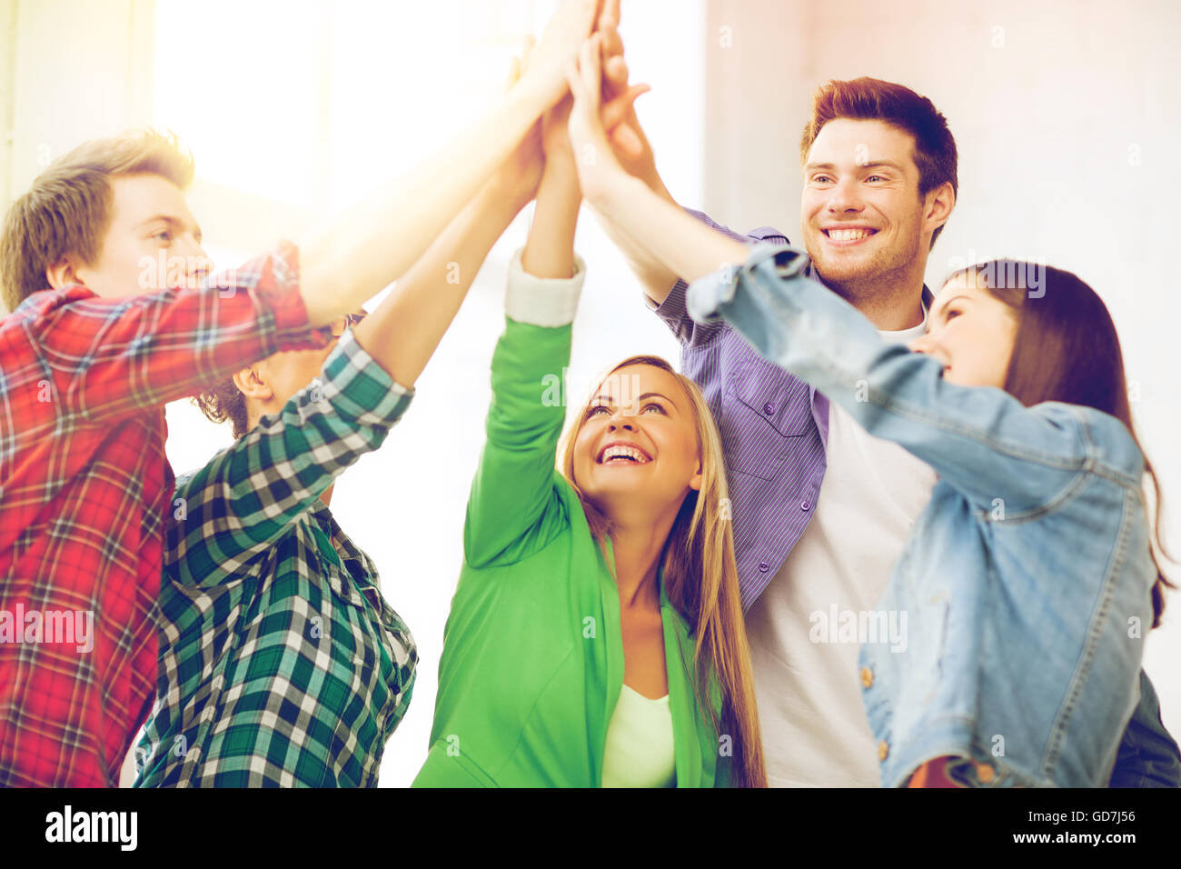 happy students giving high five at school Stock Photo - Alamy