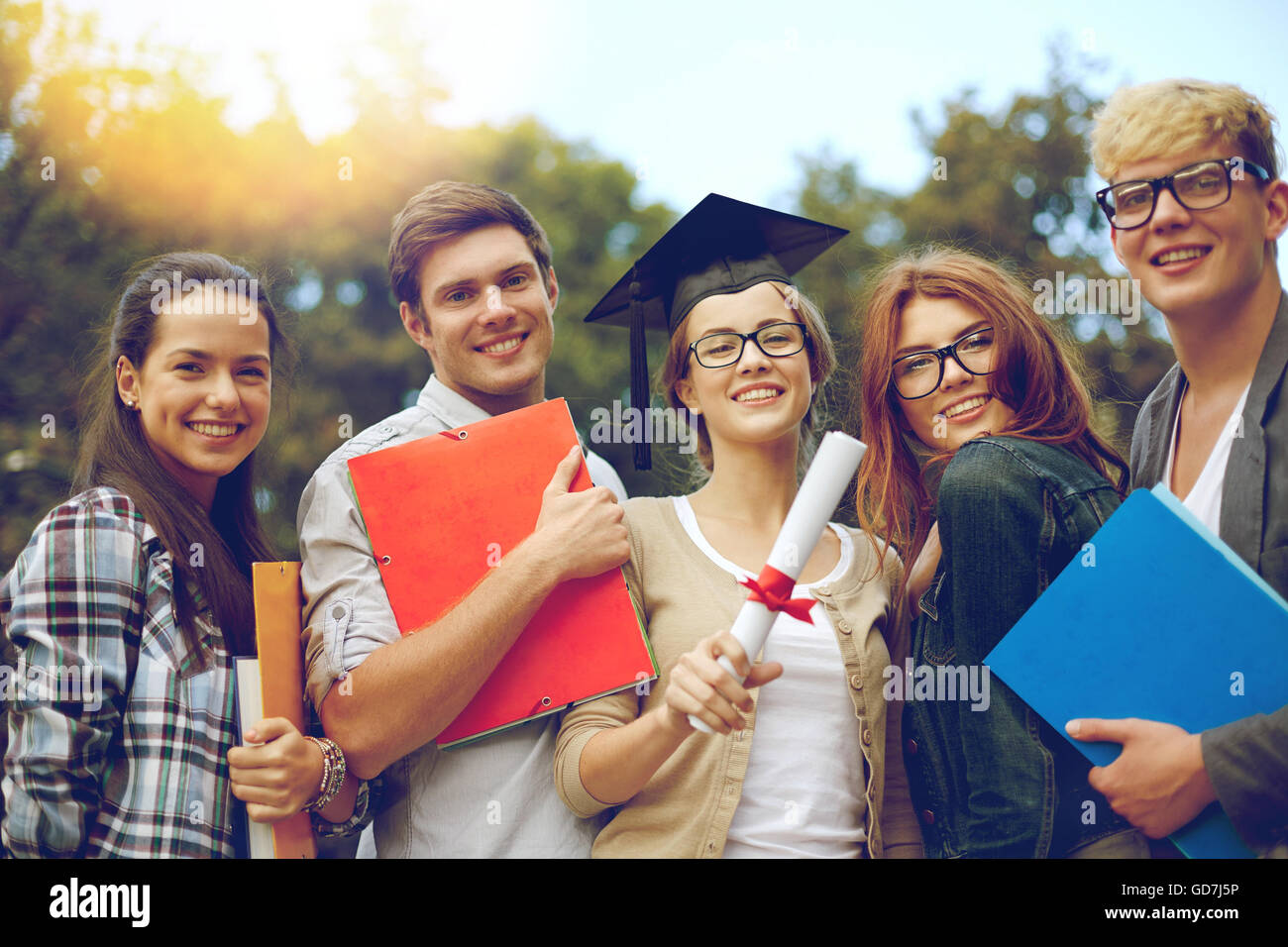 group of smiling students with diploma and folders Stock Photo - Alamy