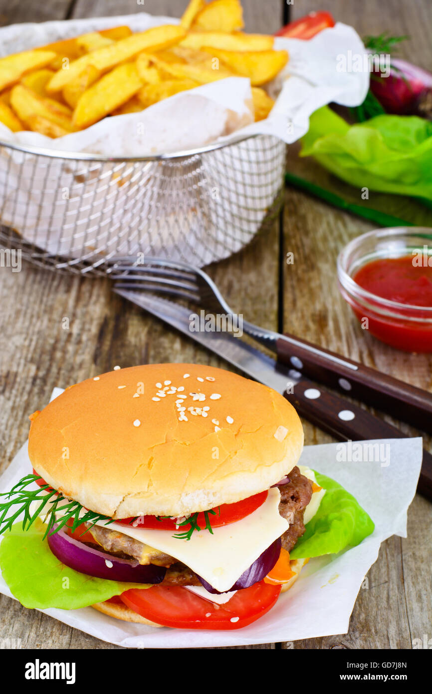 Burger on a Wooden Rustic Background Stock Photo - Alamy