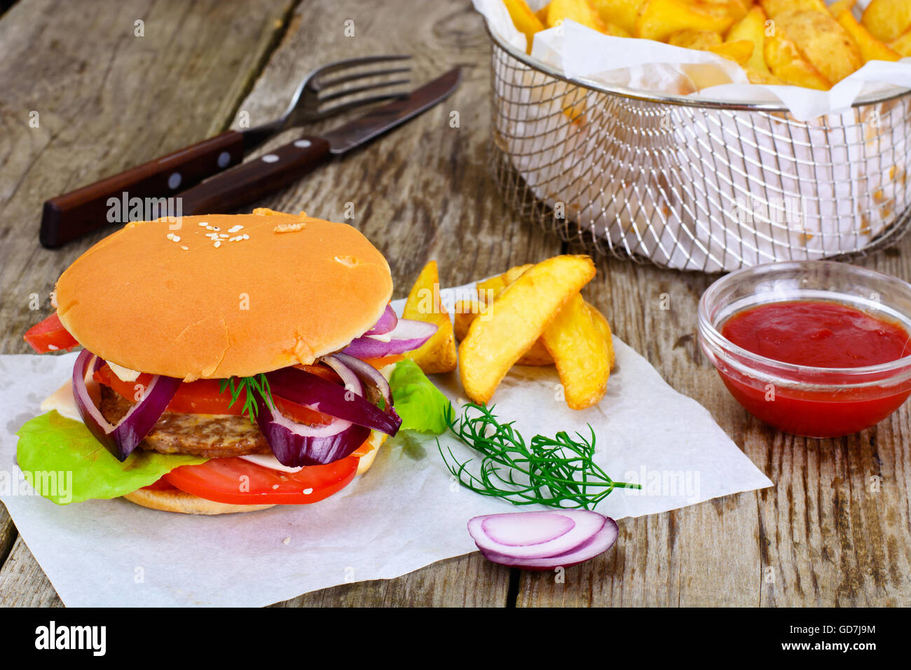 Burger on a Wooden Rustic Background Stock Photo - Alamy