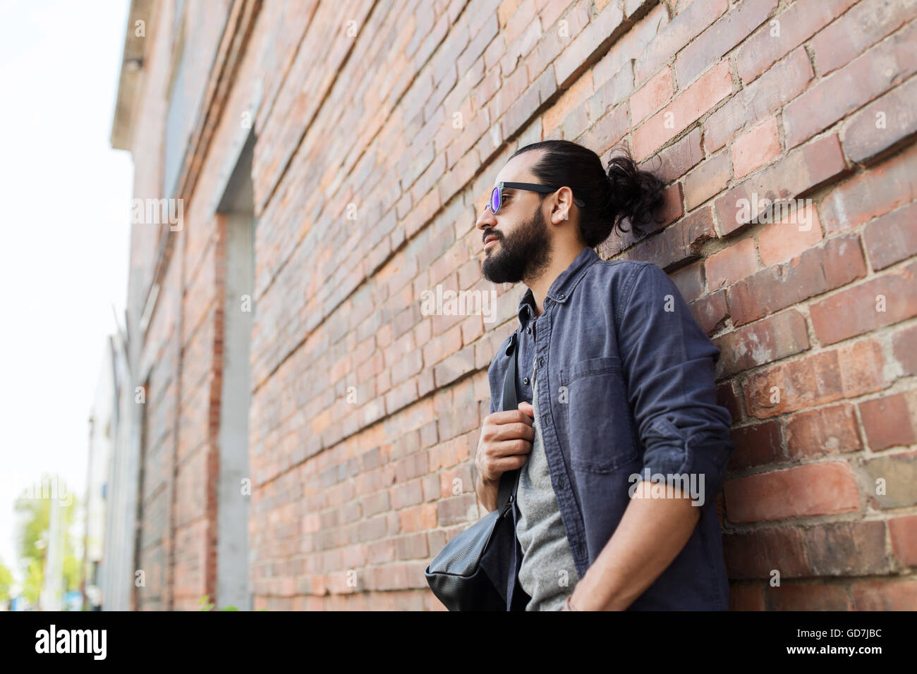 man with backpack standing at city street wall Stock Photo - Alamy