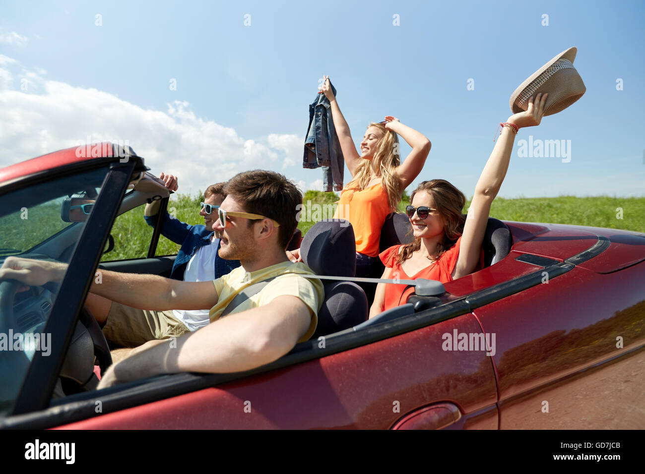 happy friends driving in cabriolet car at country Stock Photo - Alamy