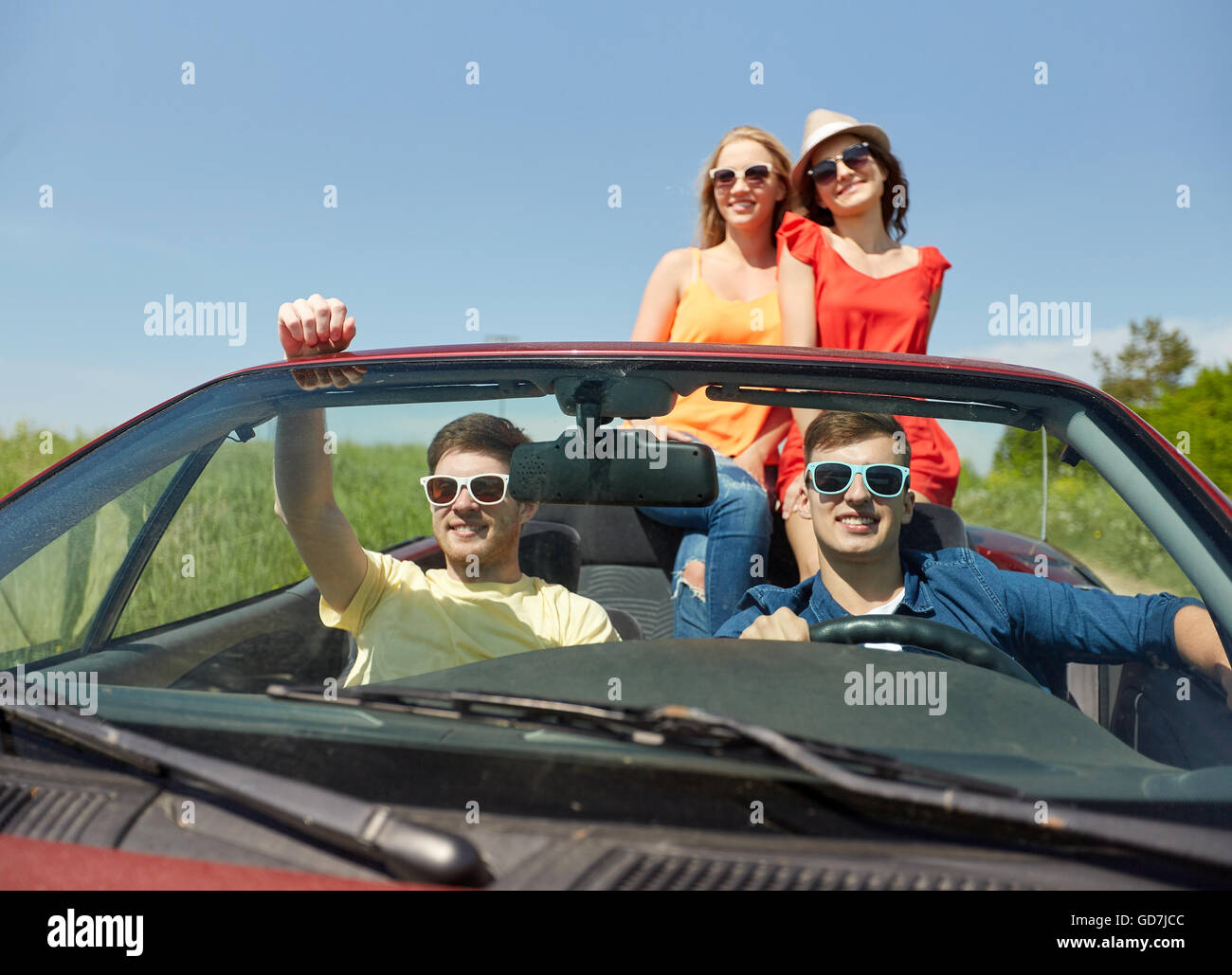 happy friends driving in cabriolet car at country Stock Photo - Alamy