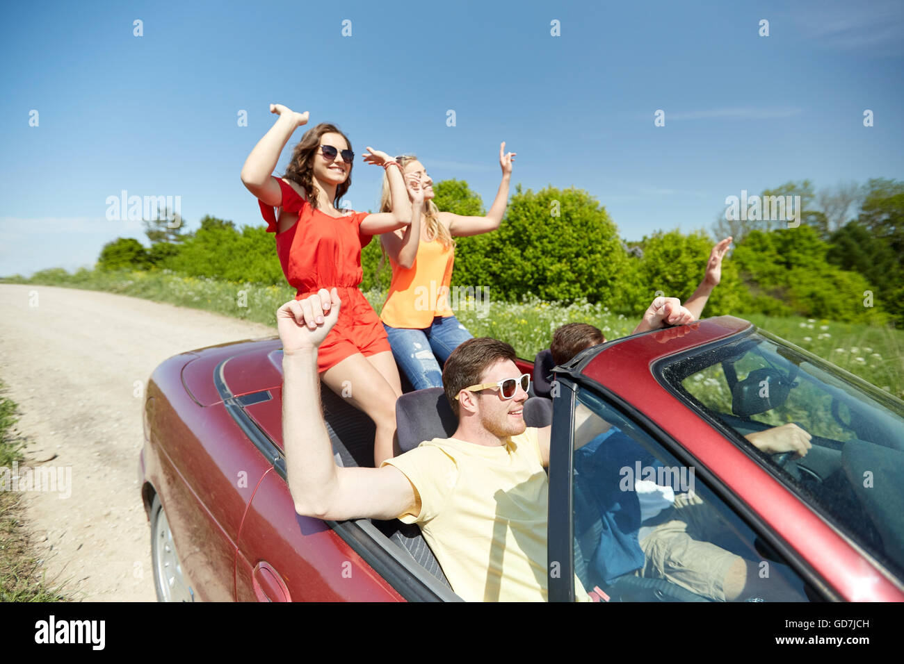 happy friends driving in cabriolet car at country Stock Photo - Alamy