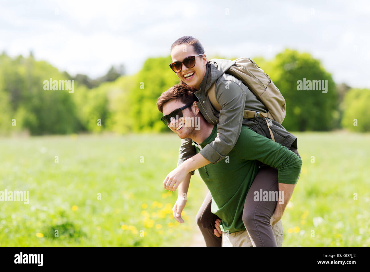 happy couple with backpacks having fun outdoors Stock Photo - Alamy
