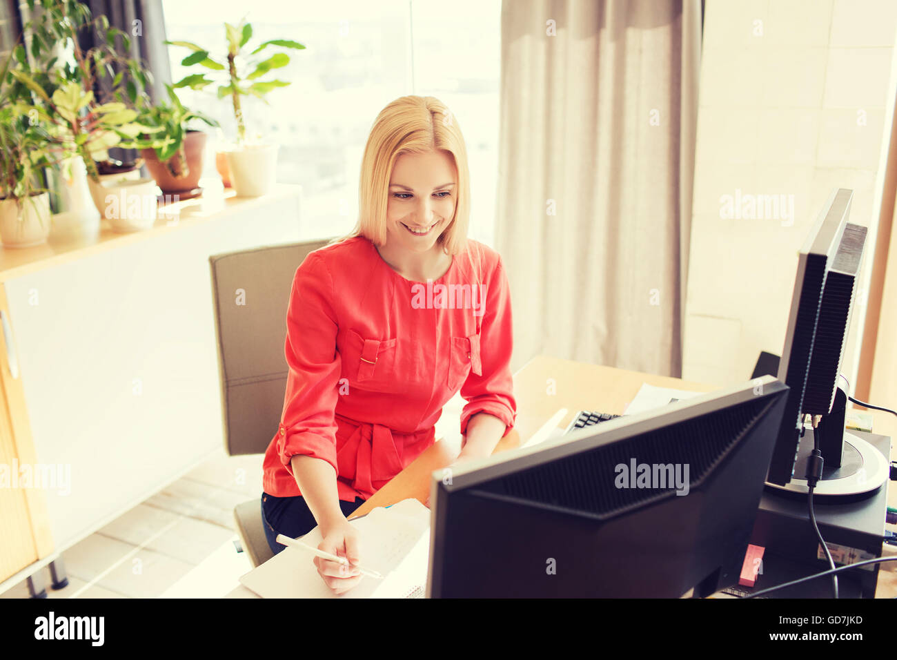 happy creative female office worker with computers Stock Photo - Alamy