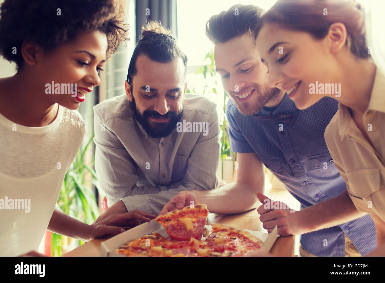 happy business team eating pizza in office Stock Photo - Alamy