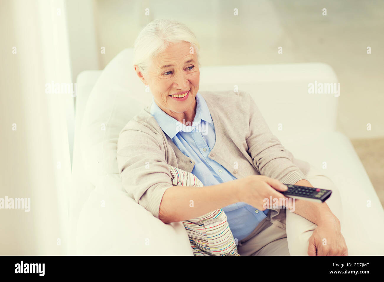 Happy elderly woman watching tv hi-res stock photography and images - Alamy