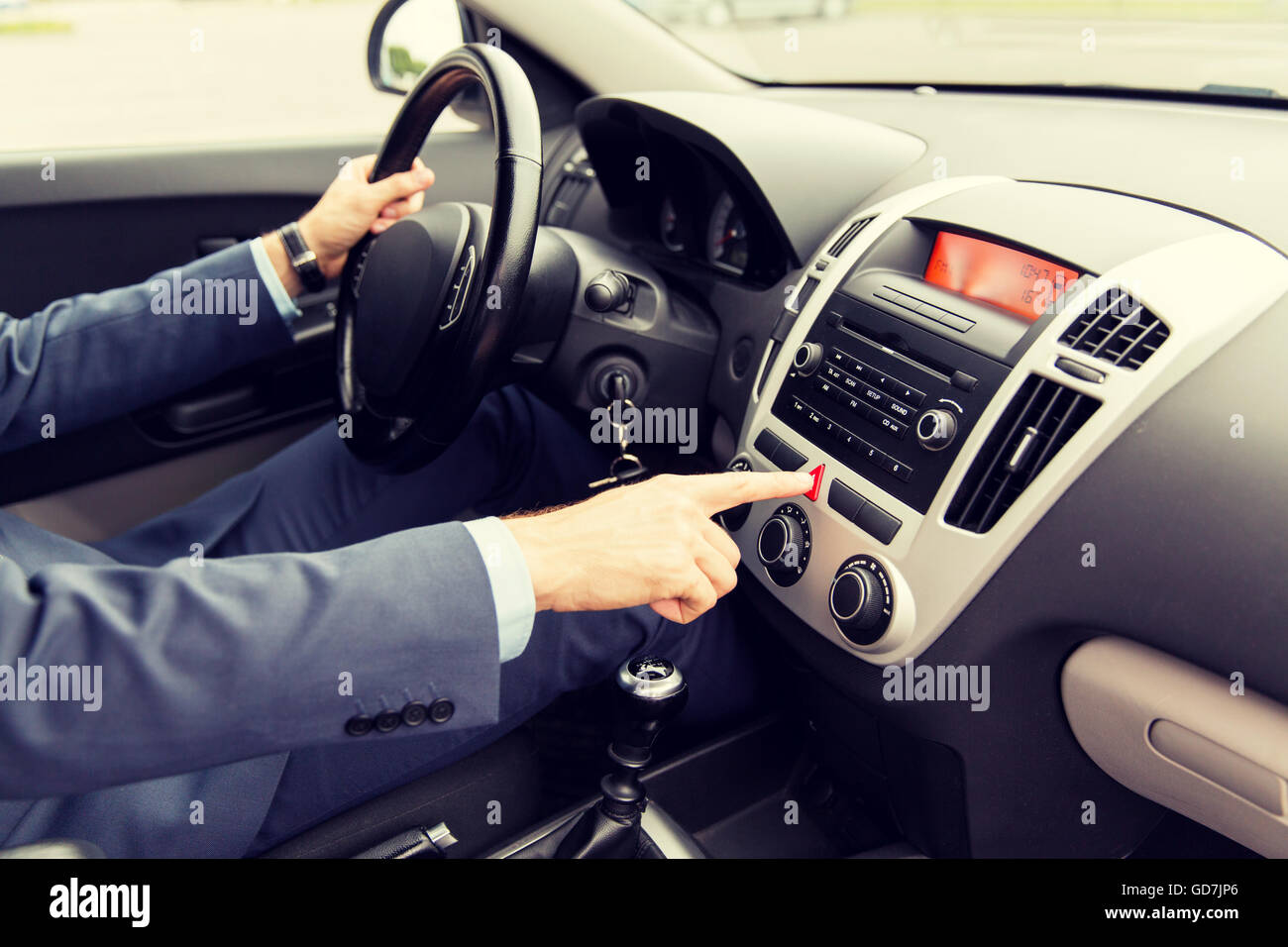 close up of man driving car and emergency button Stock Photo - Alamy