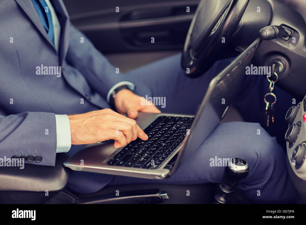 close up of young man with laptop driving car Stock Photo - Alamy