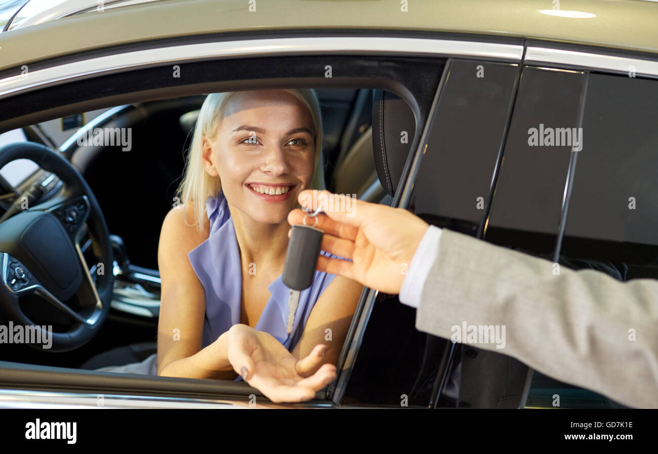 happy woman getting car key in auto show or salon Stock Photo - Alamy