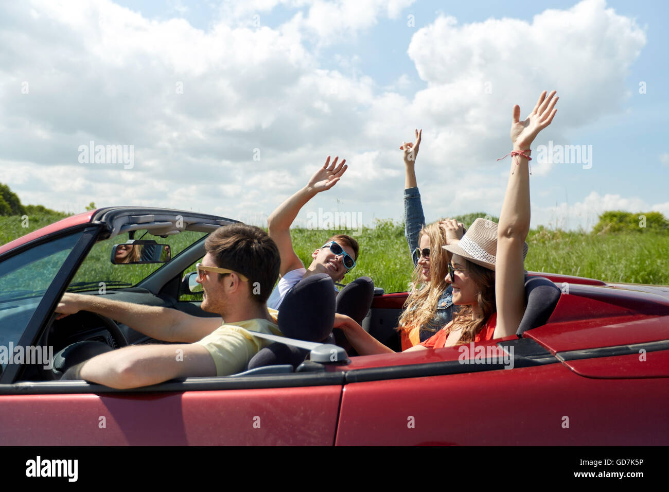 happy friends driving in cabriolet car at country Stock Photo - Alamy