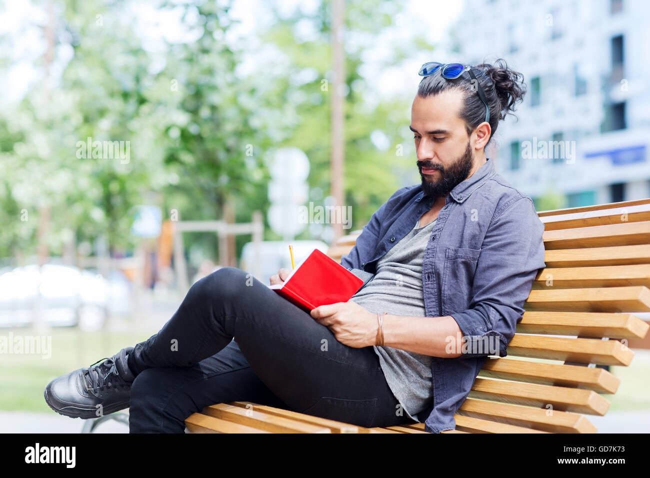 man with notebook or diary writing on city street Stock Photo - Alamy