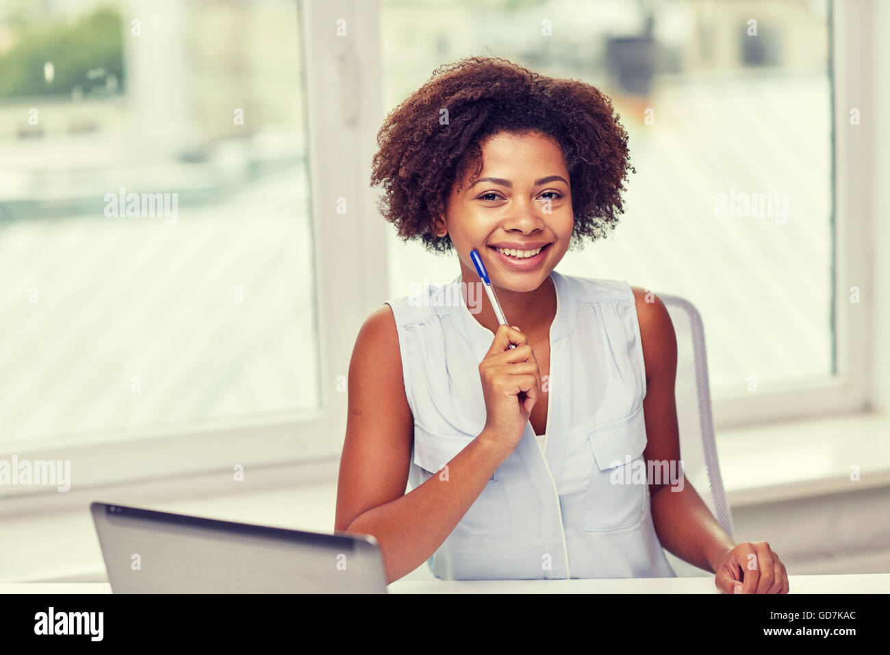 happy african woman with laptop at office Stock Photo - Alamy
