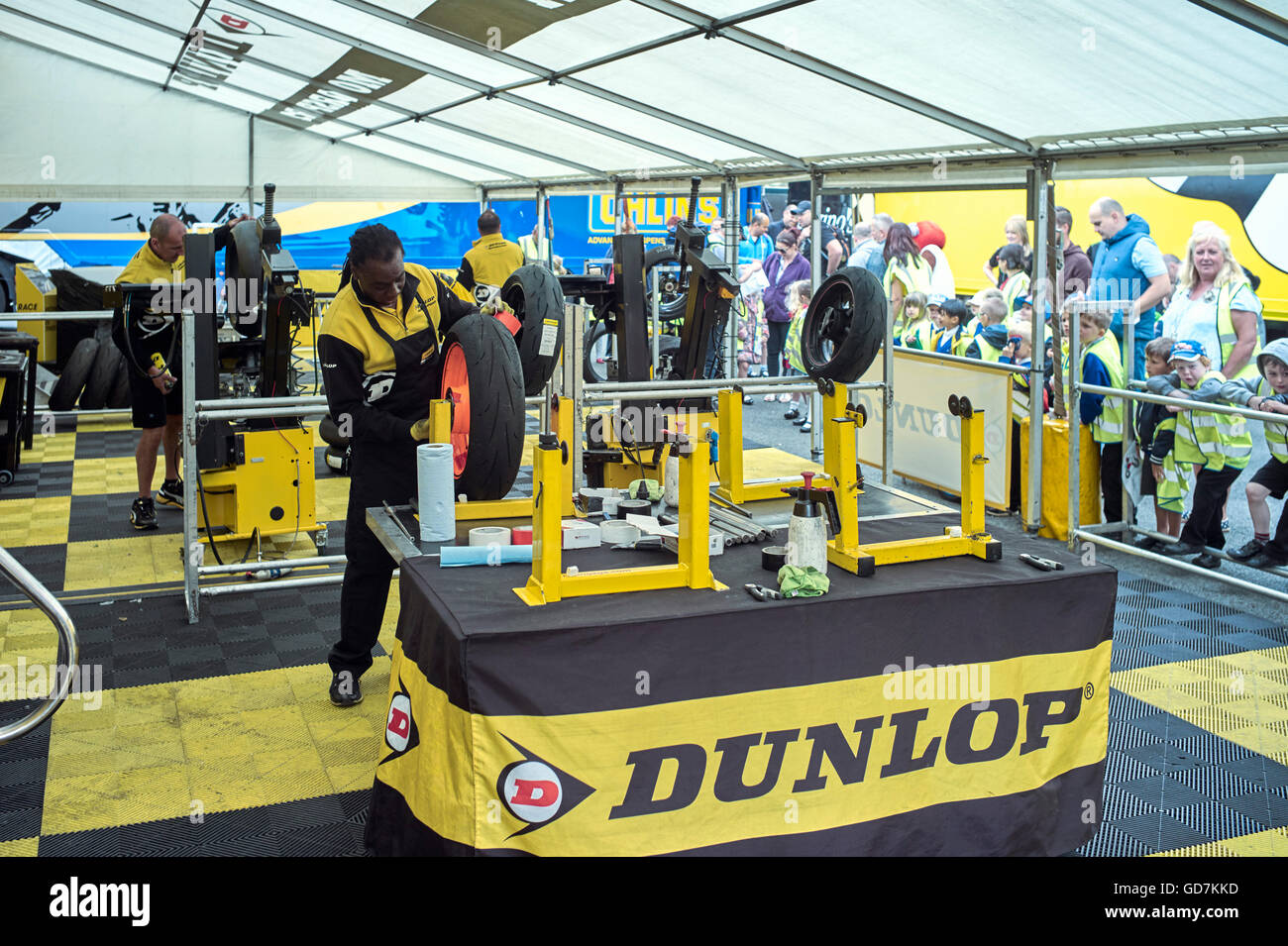 TT 2016, Dunlop stand with tyres being prepared for racing bikes and ...