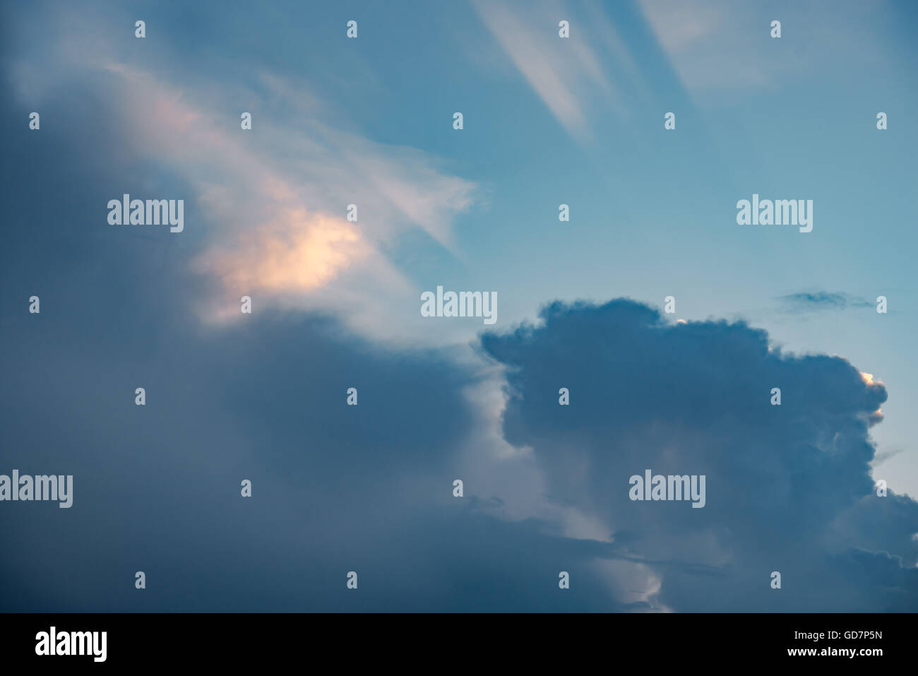 Setting sun in cloudy sky Stock Photo - Alamy