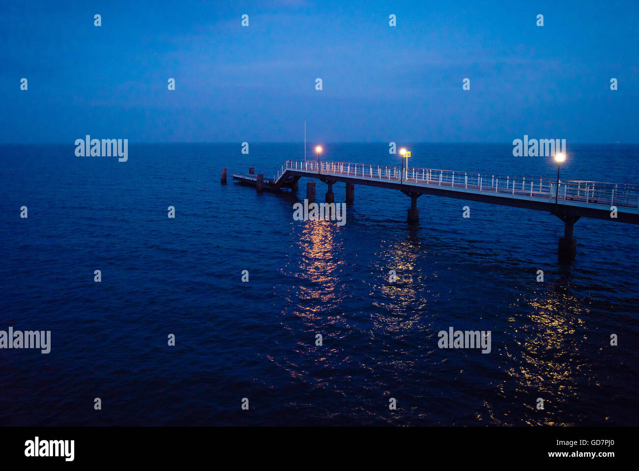sea pier at night Stock Photo - Alamy
