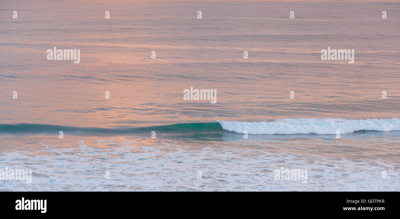 Breaking turquoise ocean wave closeup at pink sunset Stock Photo - Alamy