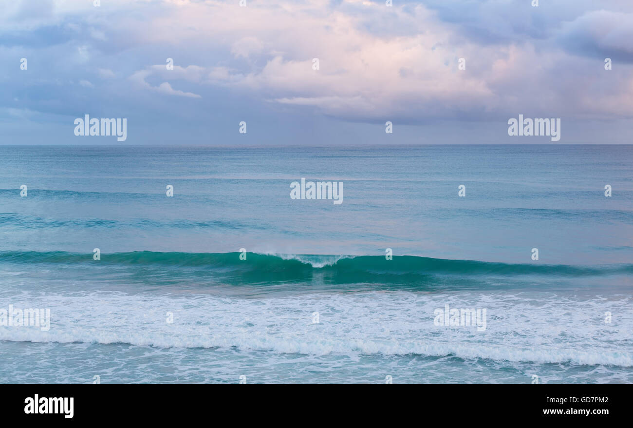 Breaking ocean wave in vivid turquoise color Stock Photo - Alamy