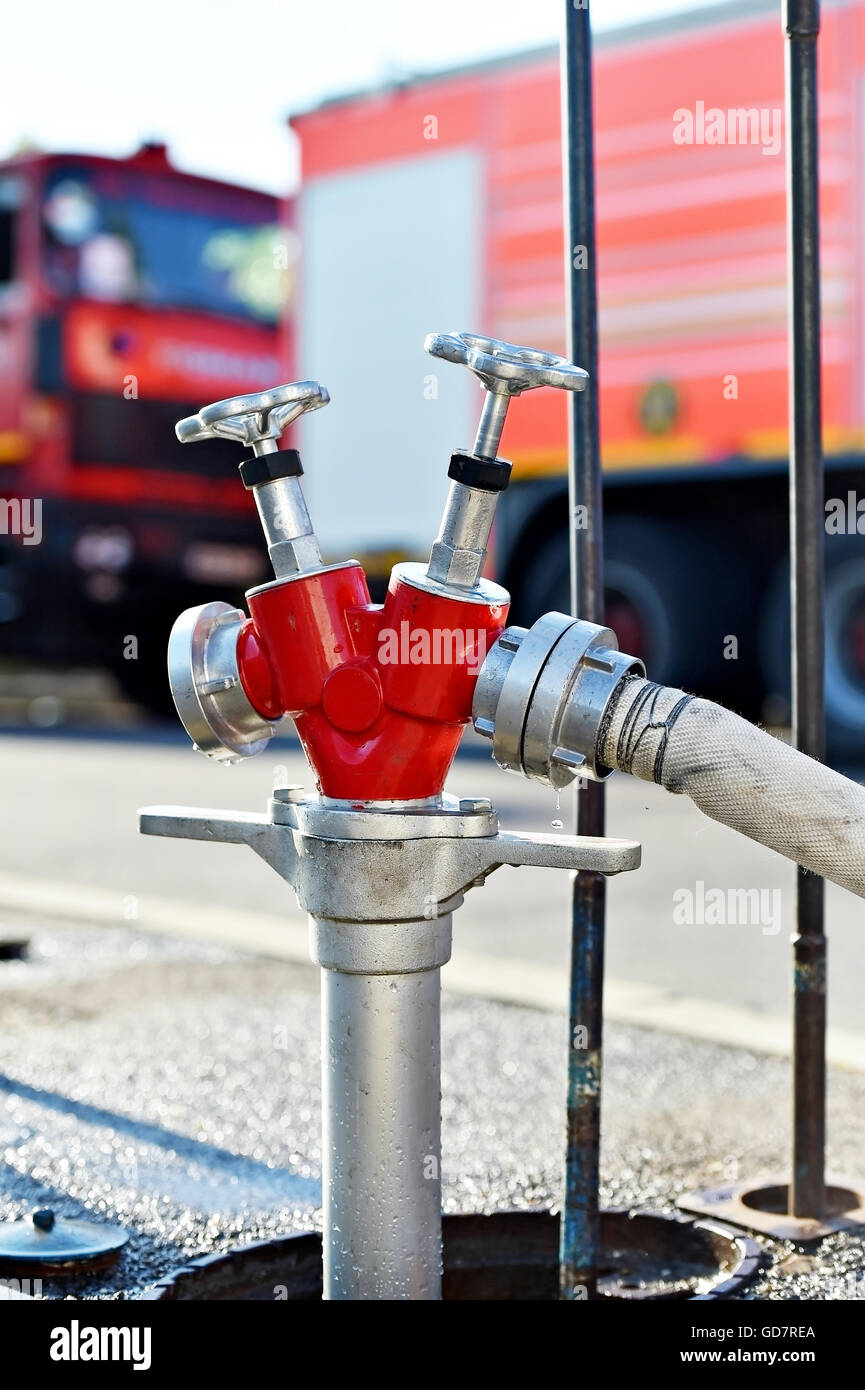 Water hose connected to hydrant during firefighting operation Stock ...