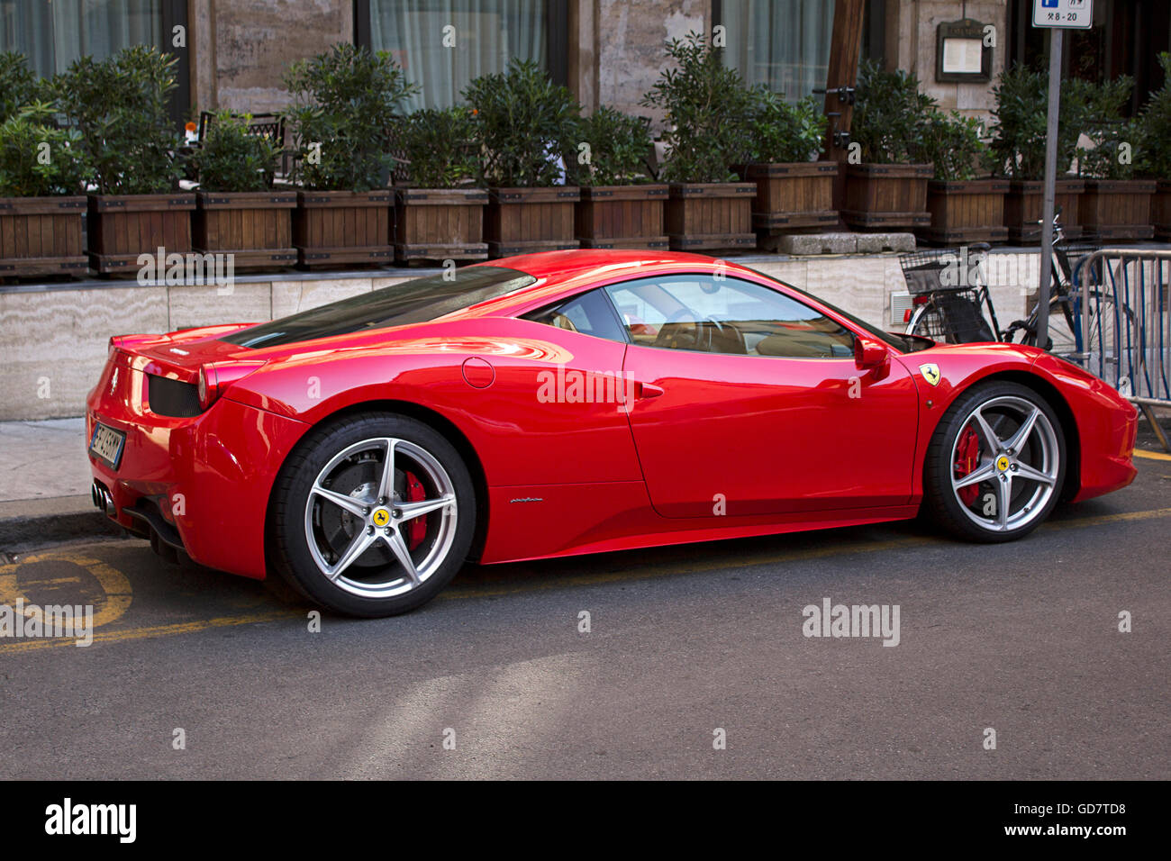 Luxury red Ferrari Italian supercar in front of Principe di Piemonte ...