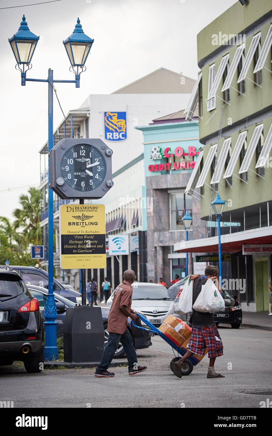 Clock hanging on building hi-res stock photography and images - Alamy
