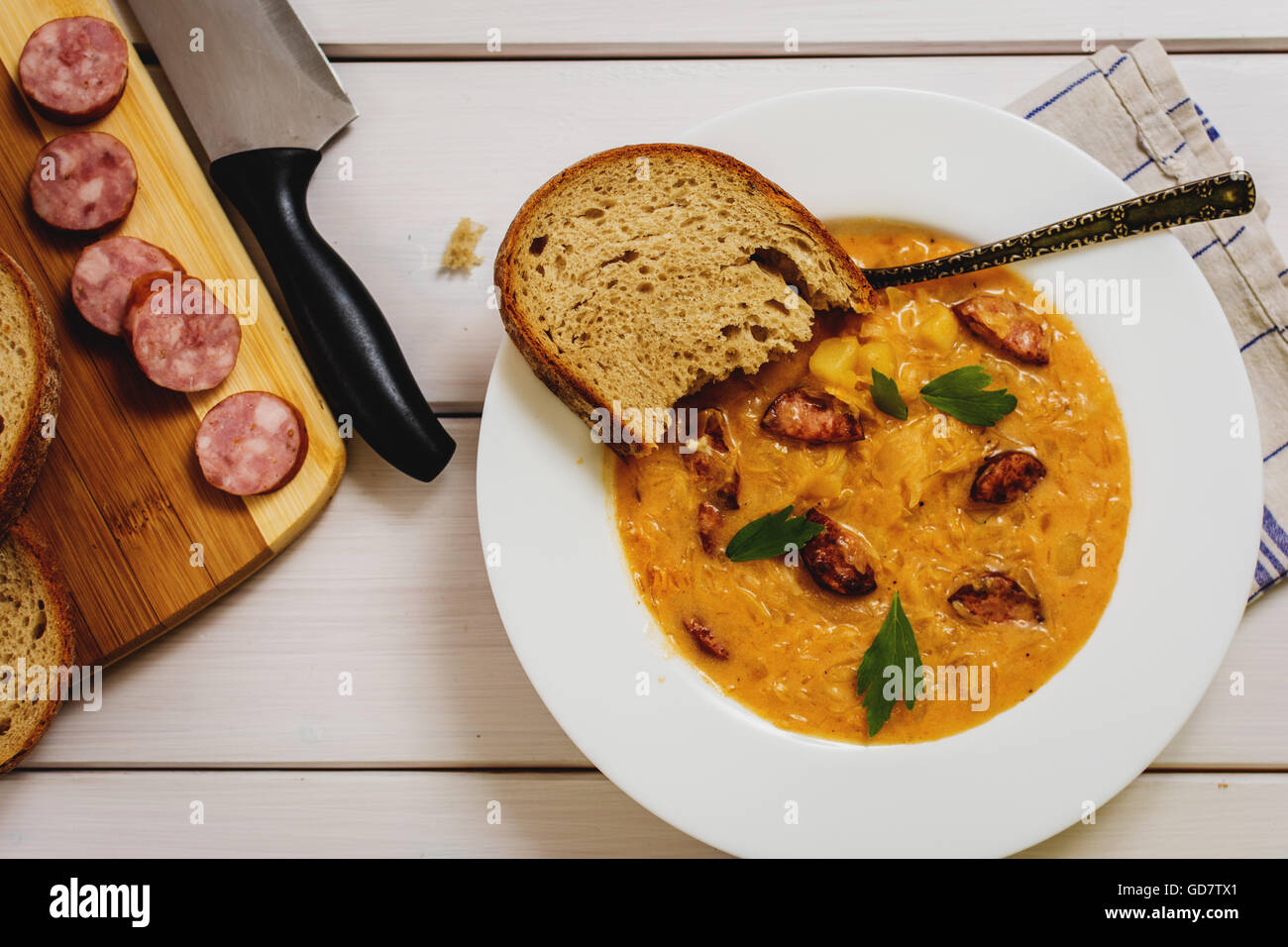 Traditional czech cuisine.Cabbage soup with sausage and homemade bread ...