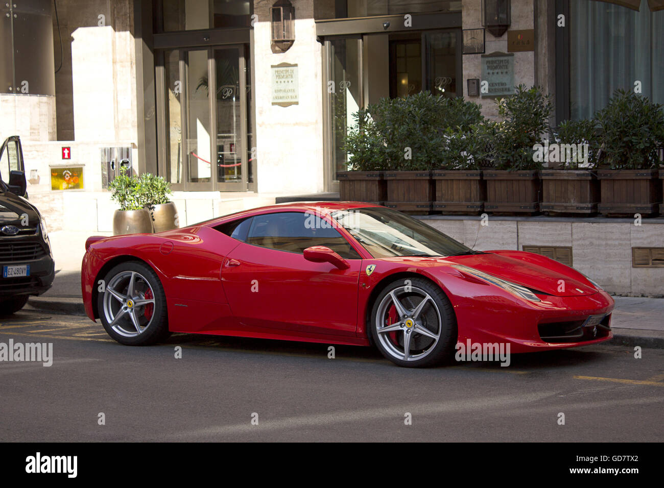 Luxury red Ferrari Italian supercar in front of Principe di Piemonte ...