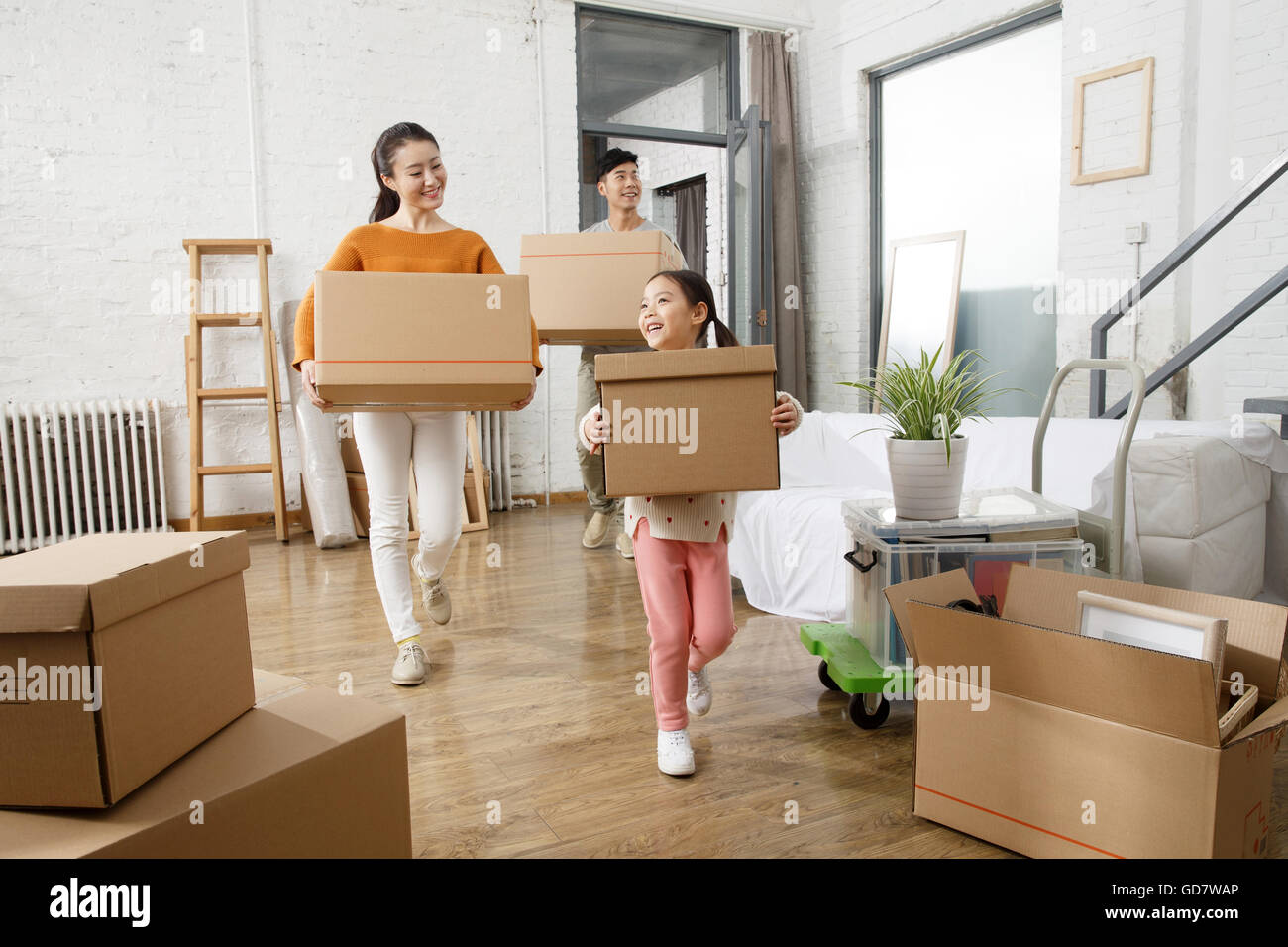 Happy family moved to new home Stock Photo - Alamy