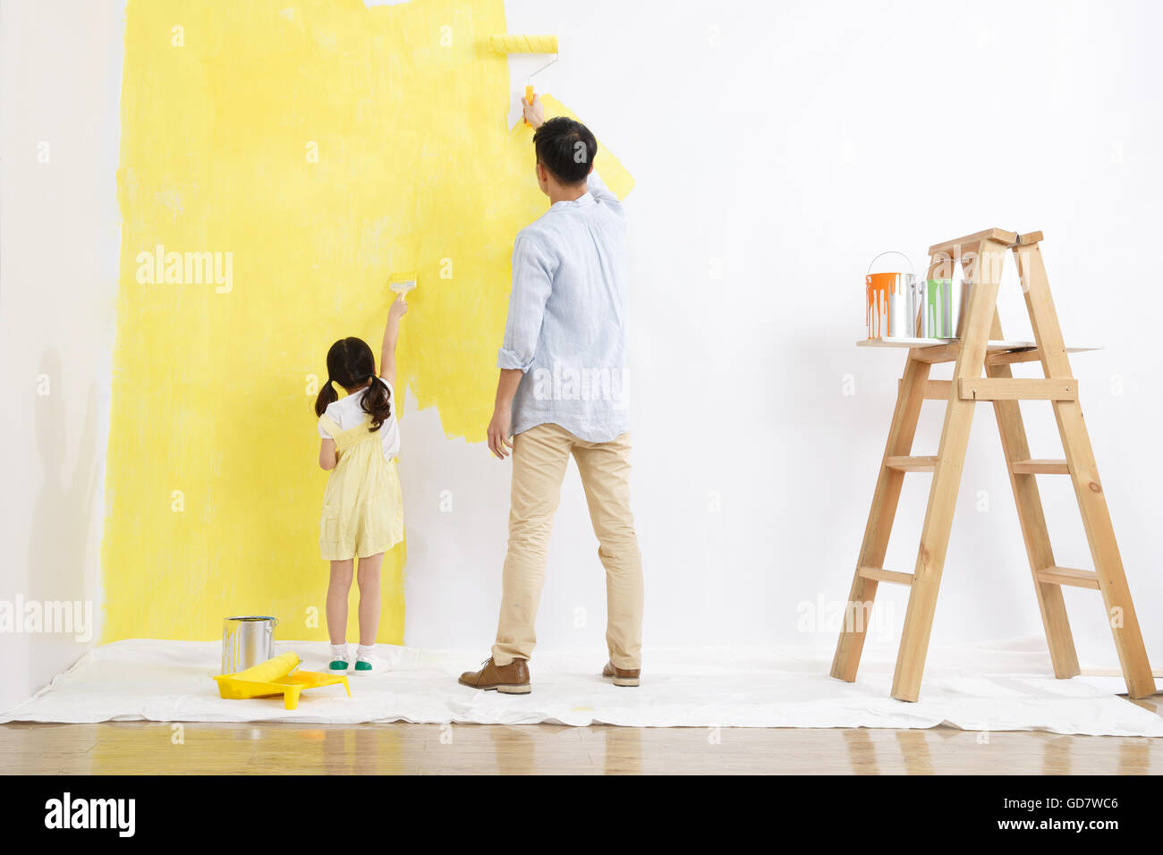 The joy of the father and daughter in the paint for the walls Stock ...