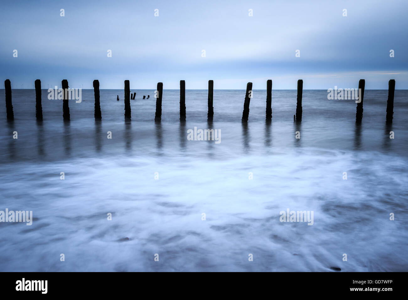 Wooden groynes on the beach with long exposure Stock Photo - Alamy