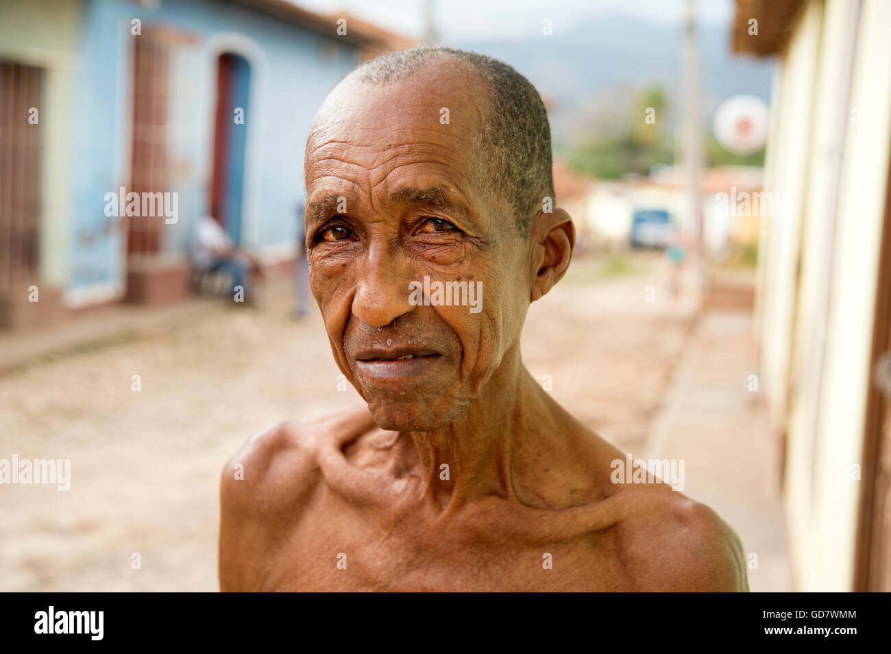 Portrait of an old Cuban man bare chested in a run down traditional ...