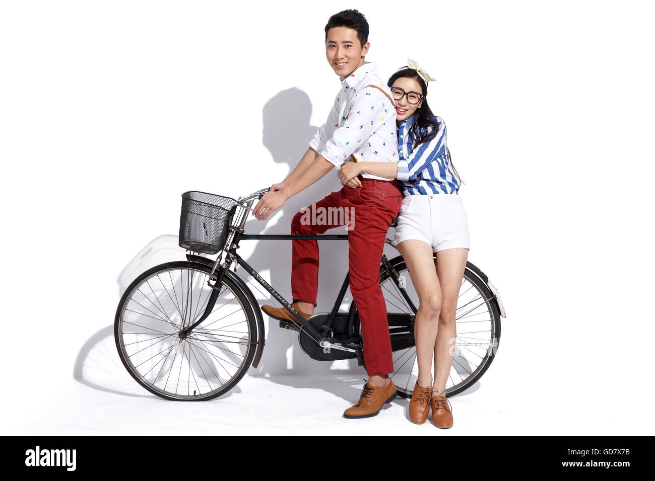 Young couple riding a bicycle Stock Photo - Alamy